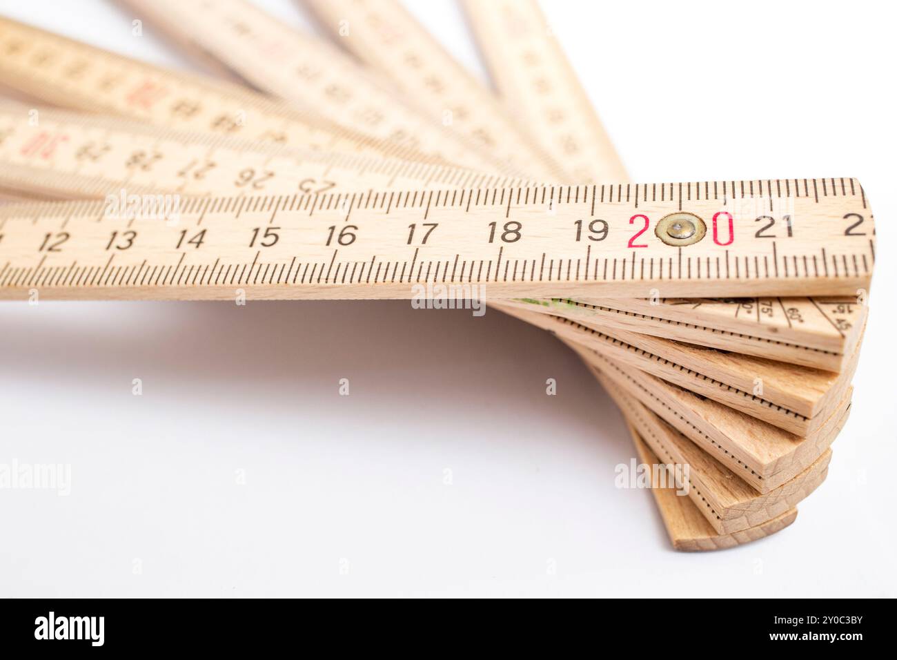 Folding measuring meter, arranged in the shape of a fan on white ...