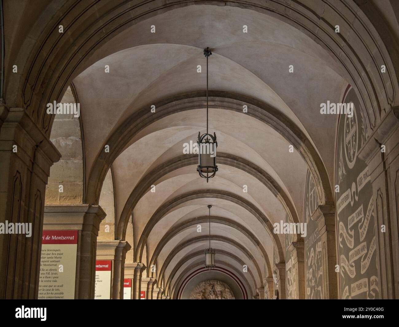 Historic arches with decorative vault and ceiling lamp inside ...