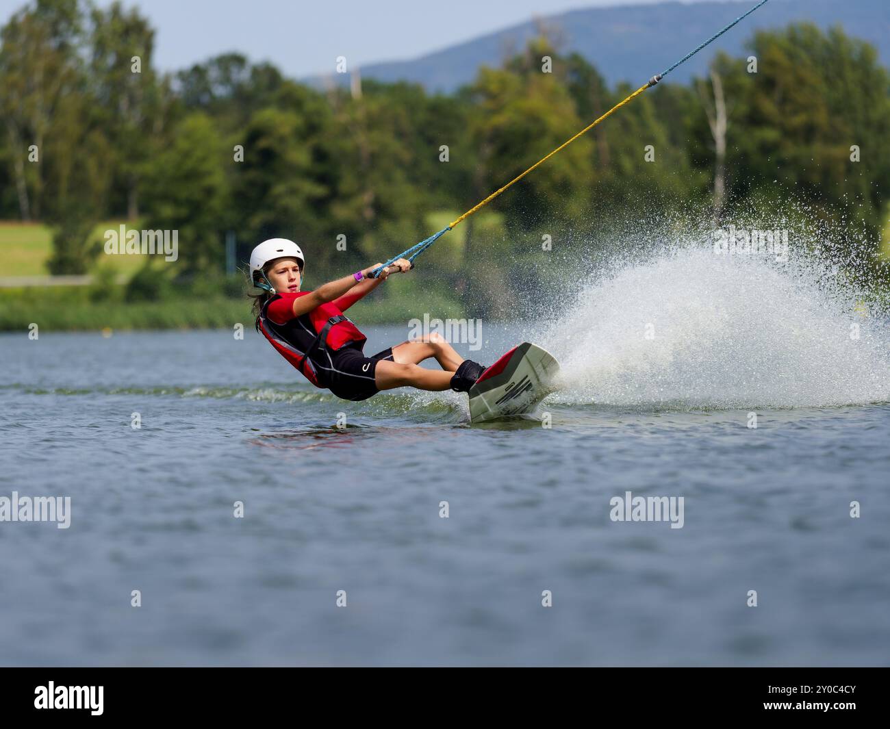 Boy or girl, summer holiday with wakeboard, water splashes, red life ...