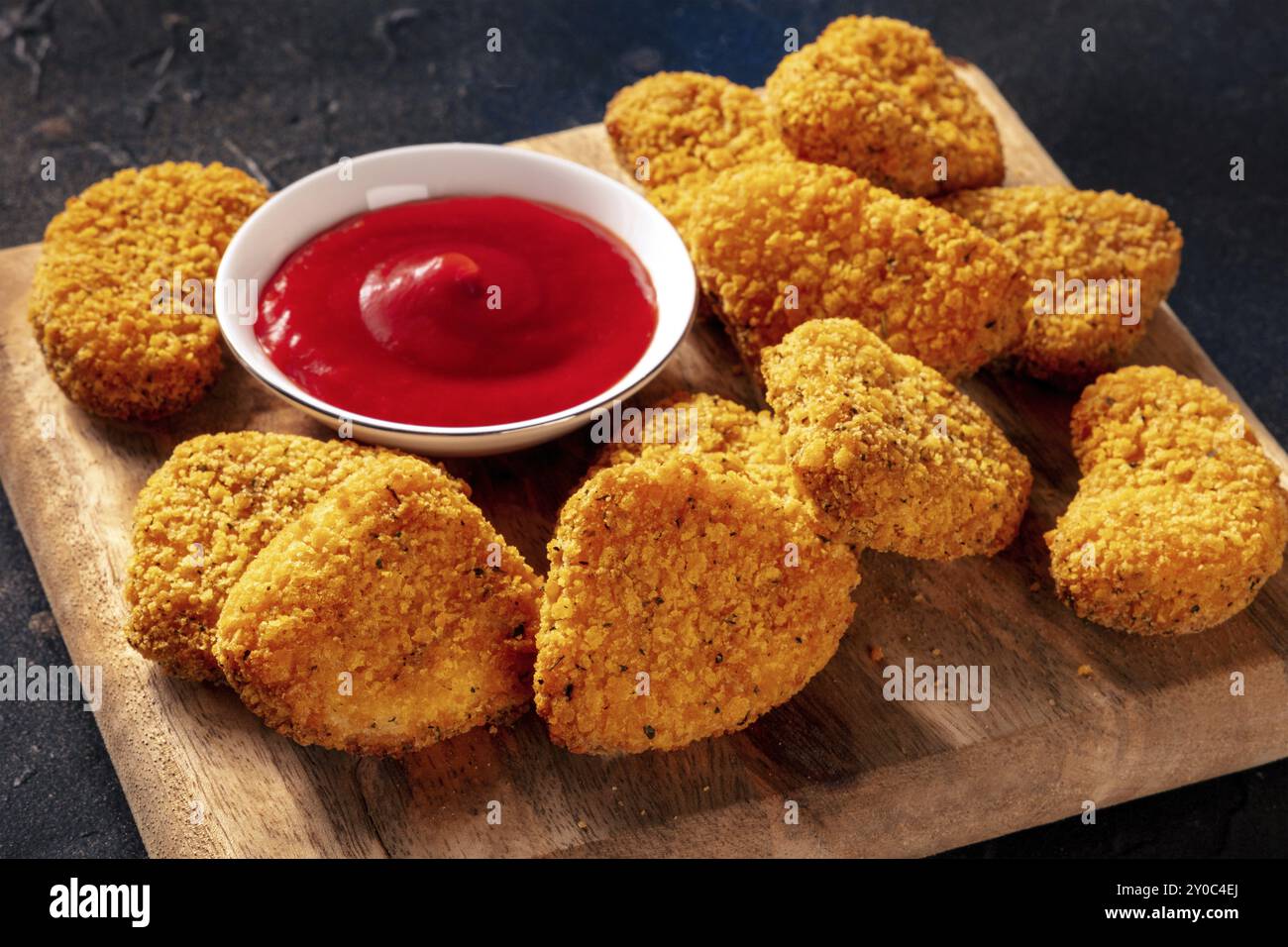 Chicken nuggets with ketchup on a black slate background. A fast food ...