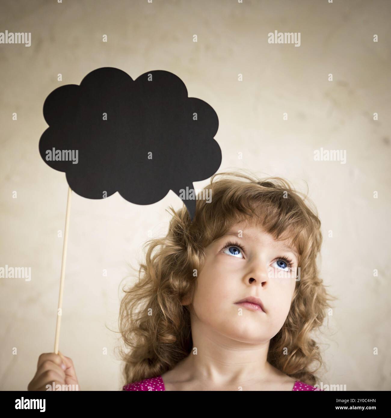 Confused child with paper cloud Stock Photo - Alamy