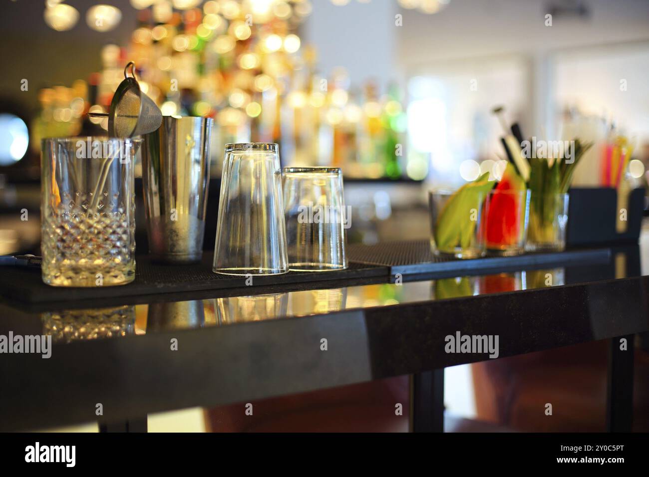 Classic bar counter with bottles in blurred background Stock Photo - Alamy