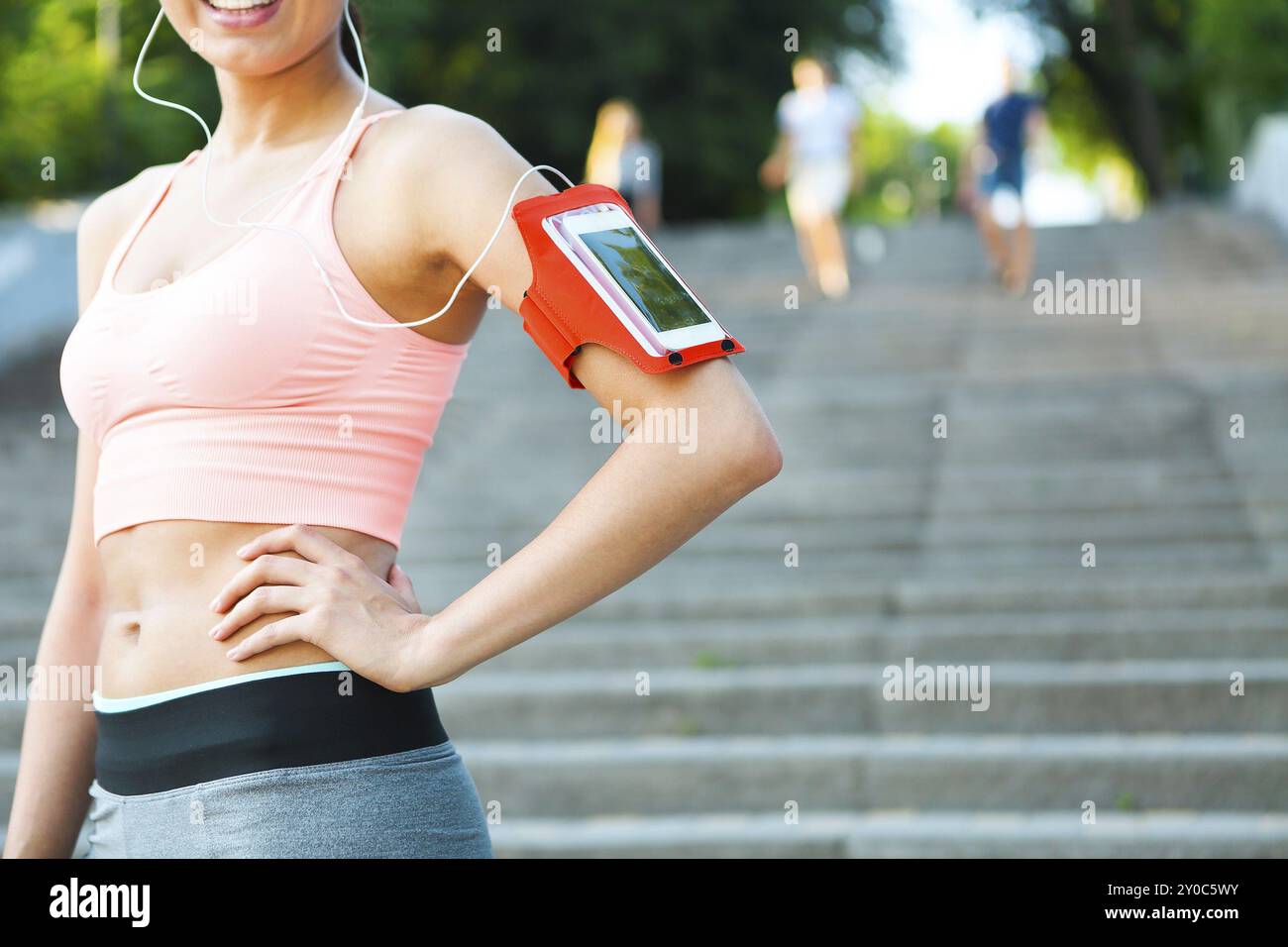 Beautiful young sportswoman listens hi-res stock photography and images ...