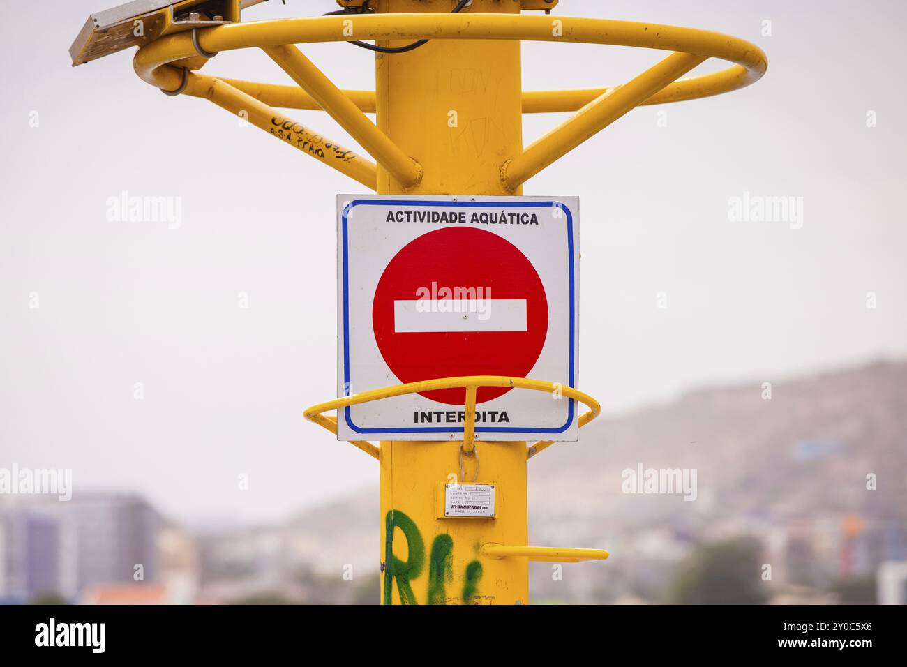 Yellow mast with traffic sign Stock Photo - Alamy