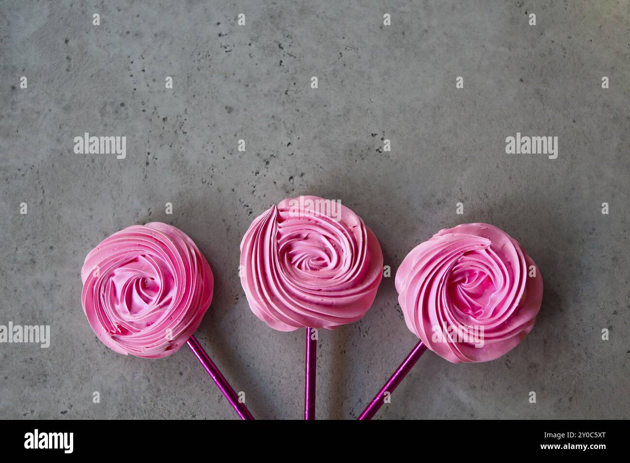 Cool sweet meringues in the roses form. Birthday sweets Stock Photo - Alamy