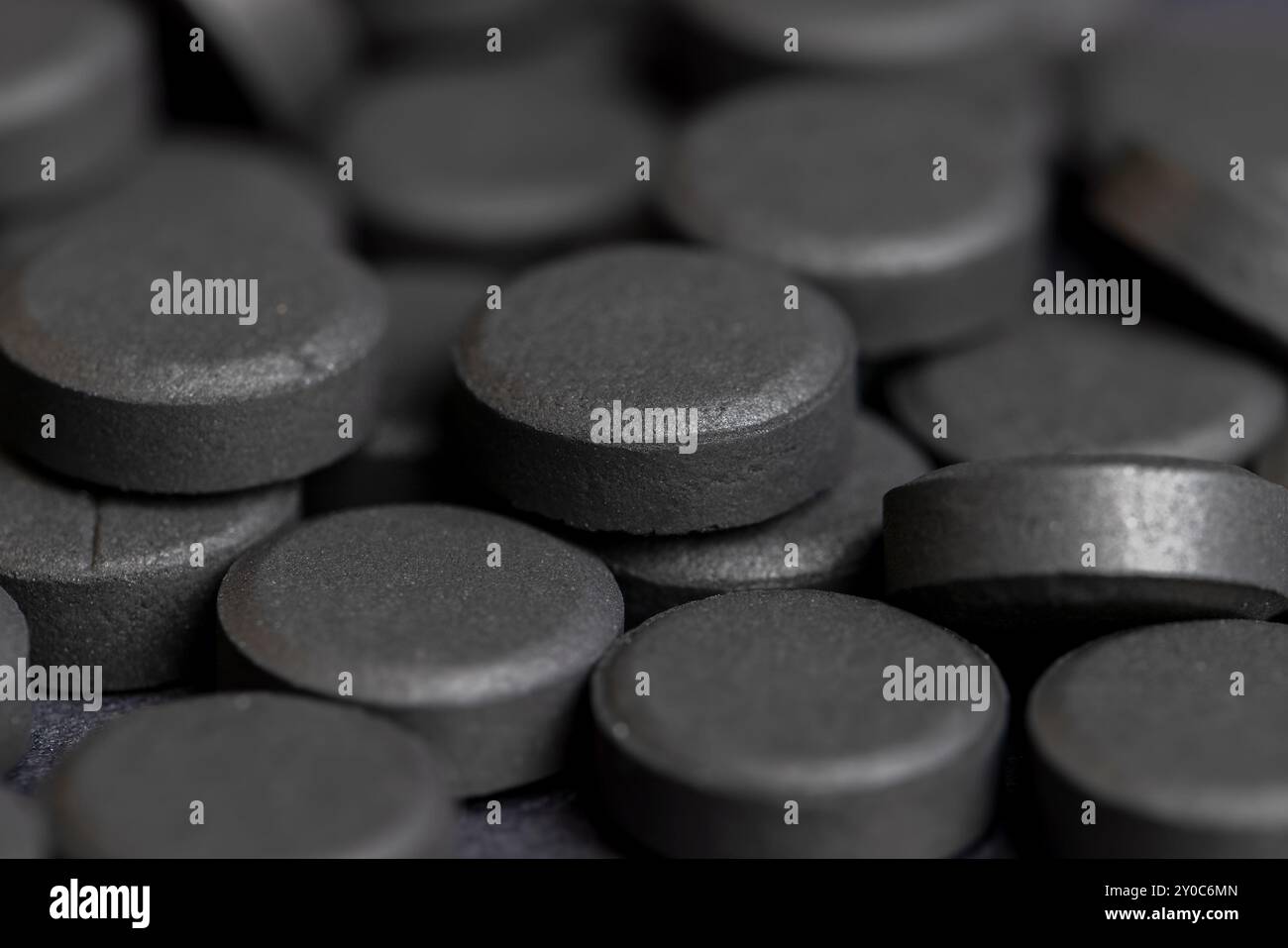 Open and unpacked tablets of black color close-up, several of the same ...