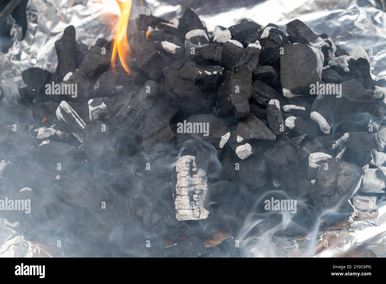 Smoking barbeque coals with smoke and flames Stock Photo - Alamy