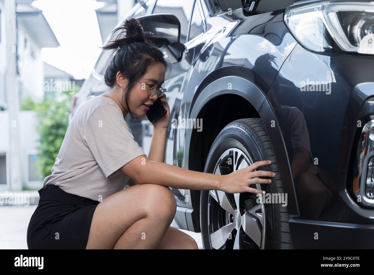 Beautiful young female bicycle mechanic talking to a customer using ...