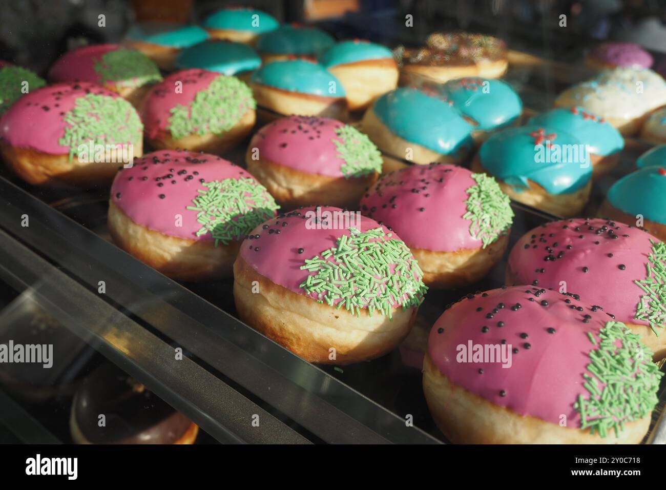 A vibrant and colorful display of delicious donuts presented in a ...
