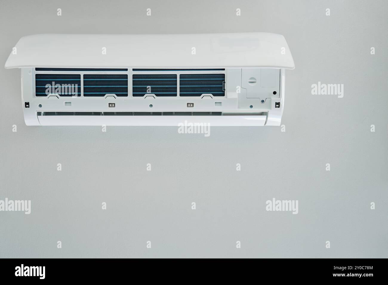 White air conditioner unit is mounted on wall, ready for maintenance ...