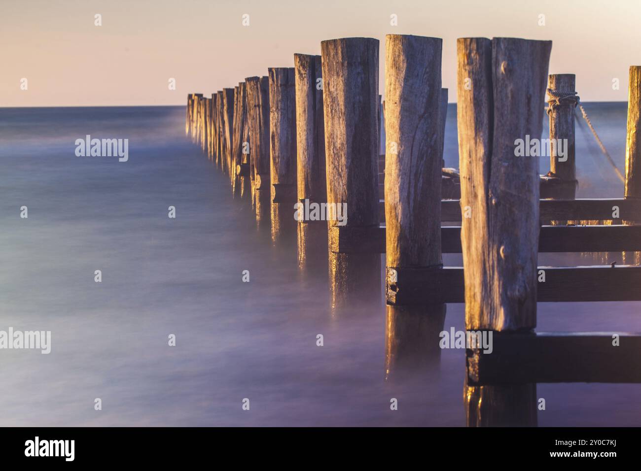Smooth water around a jetty Stock Photo - Alamy