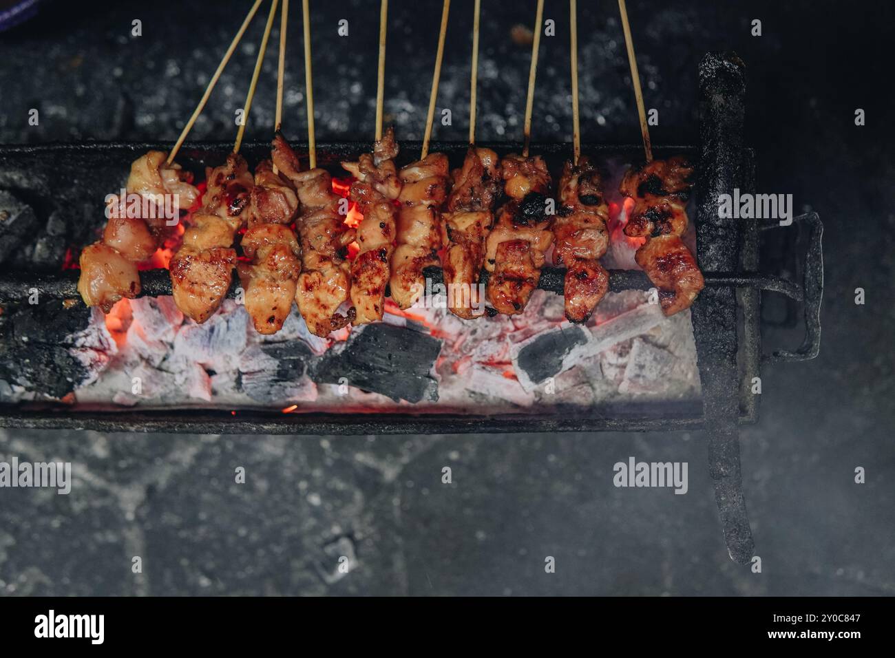 The process of making Indonesian chicken satay in traditional way using ...