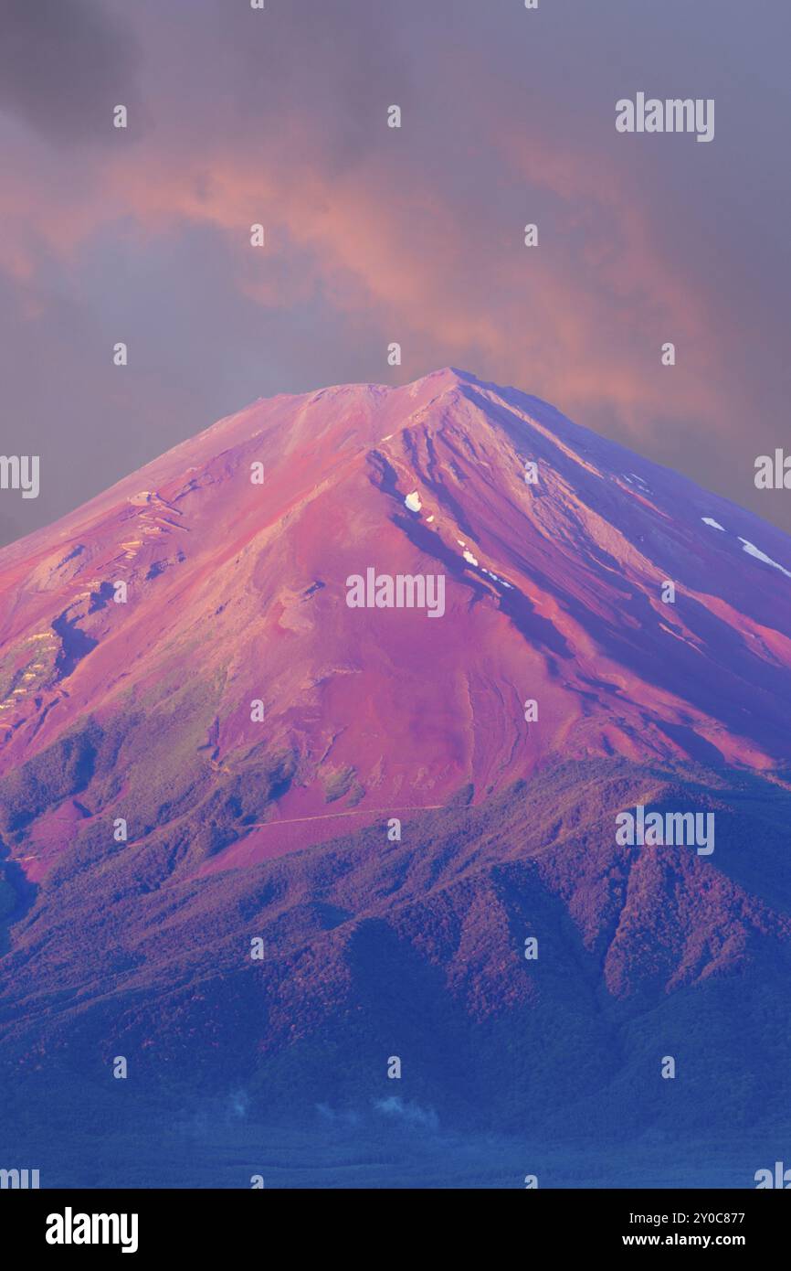 Beautiful pink sky lights up the red volcanic cone top of Mount Fuji in ...