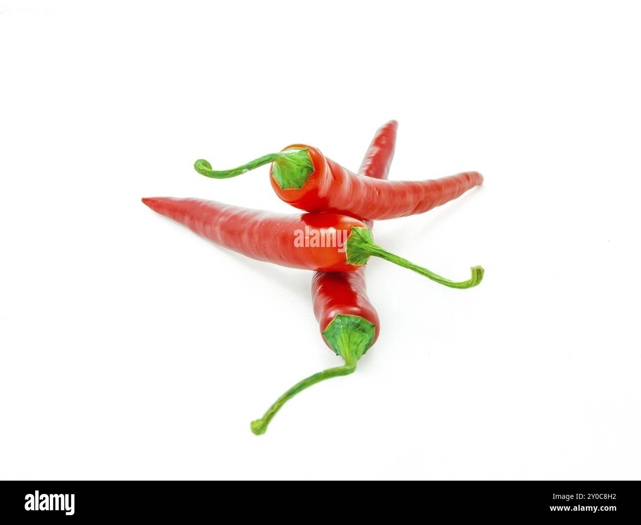 Three red chilies isolated towards white background Stock Photo - Alamy