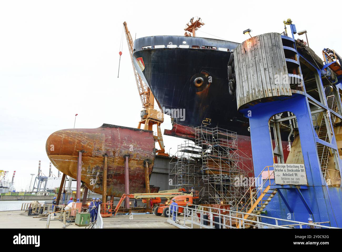 Welding and cutting work on a ship's hull in dockyard. Welding and cutting work in dockyard ...