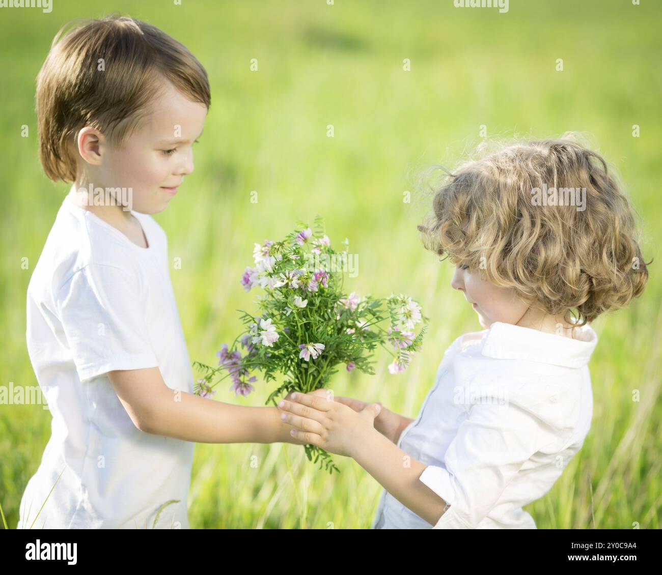 Boy giving girl flowers smiling hi-res stock photography and images - Alamy