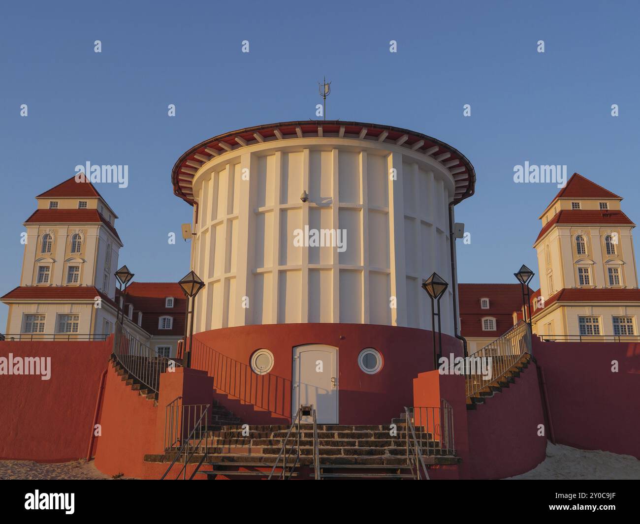 A symmetrical historic building with red and white colours and lanterns ...