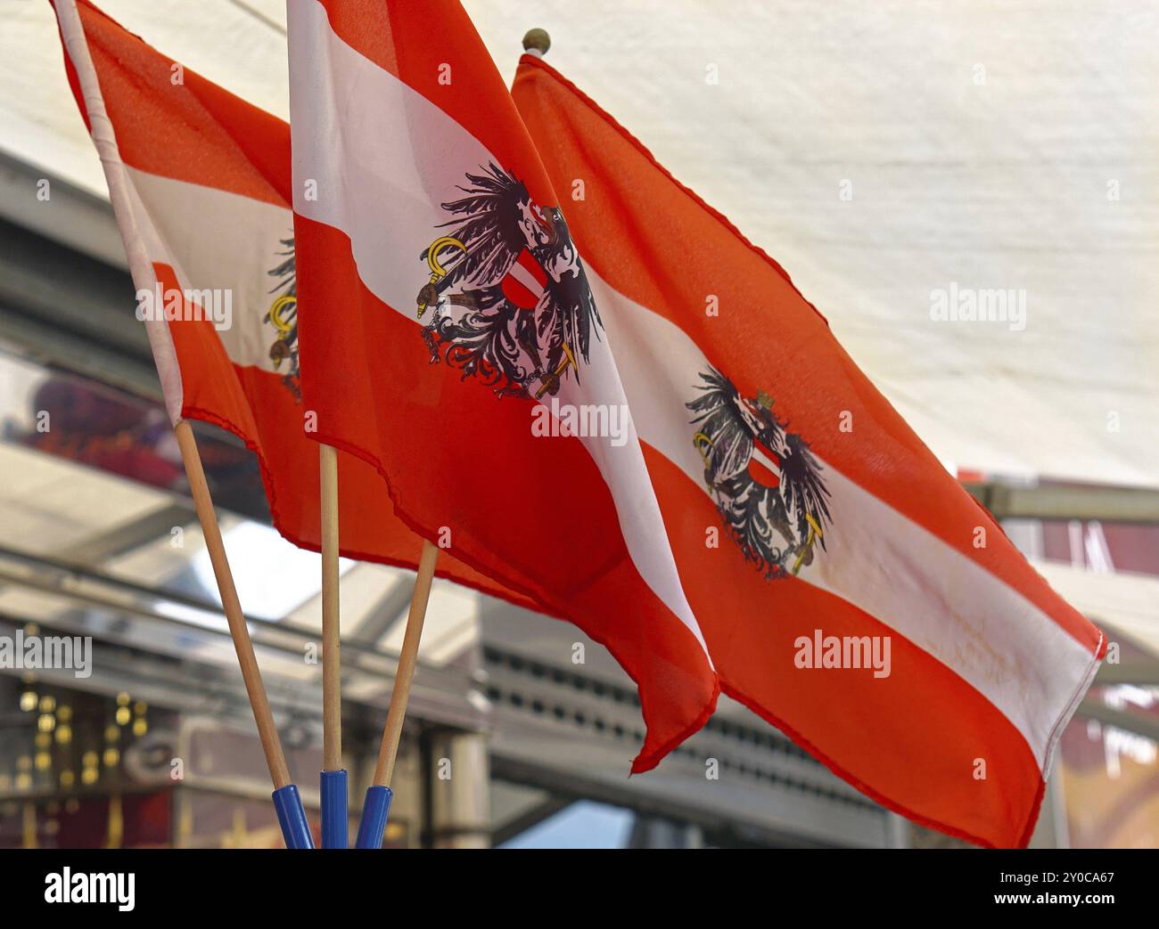 Three Austrian flags with eagles Stock Photo - Alamy