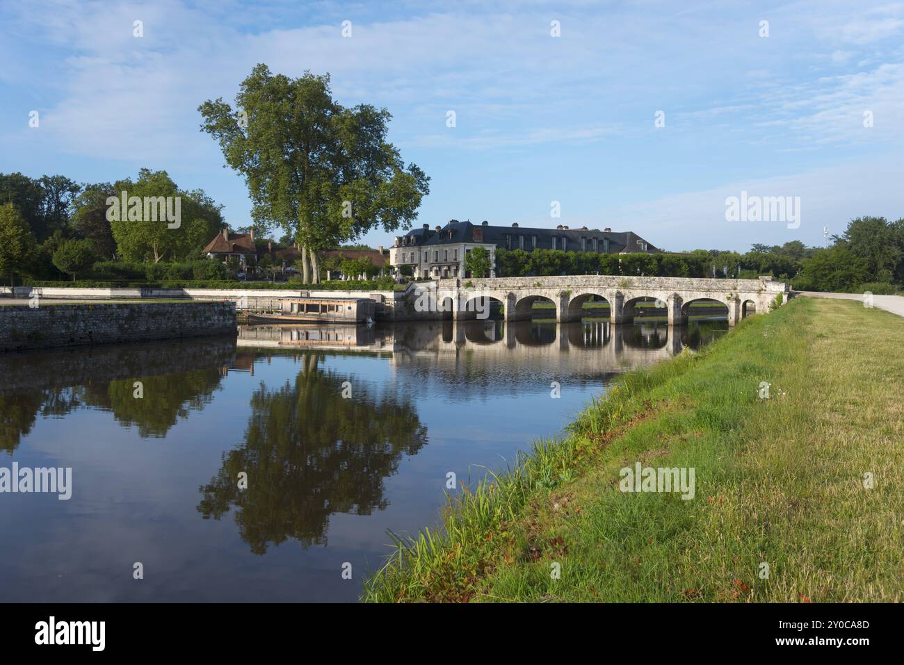 Picturesque landscape with river and stone arch bridge, surrounded by ...