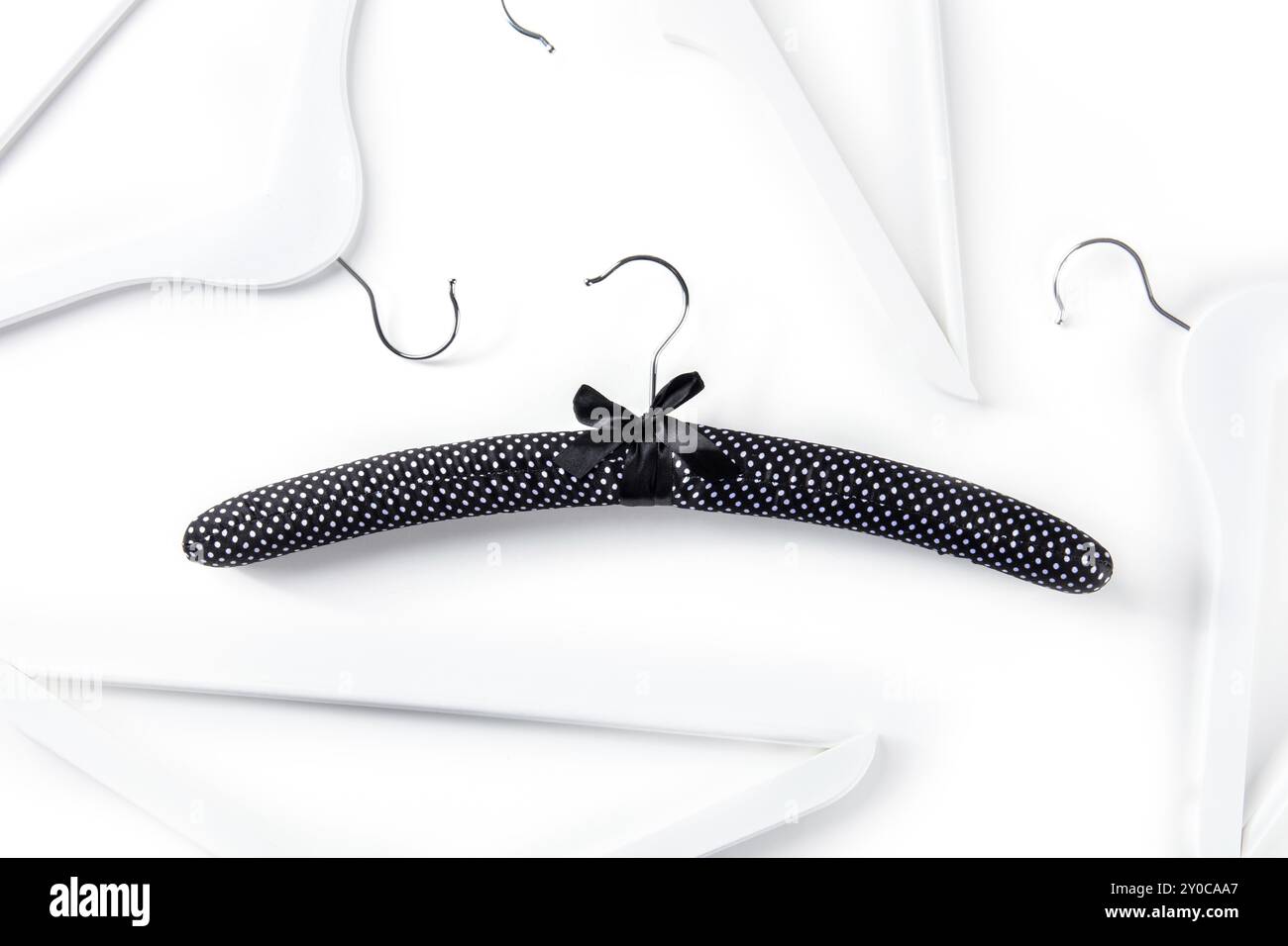 Exclusive fashion. Black satin hanger for delicate clothes surrounded ...