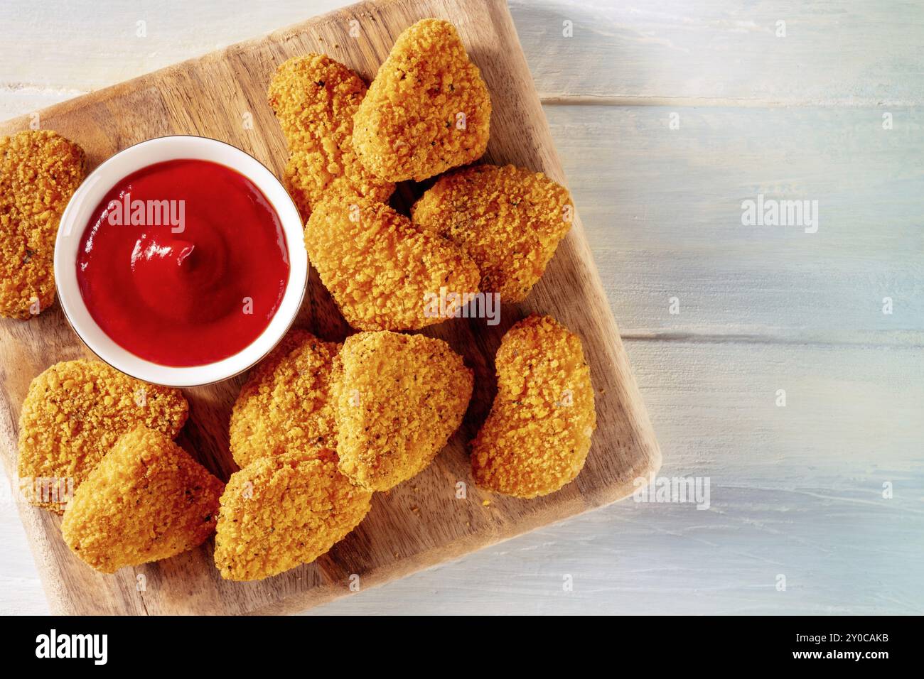 Chicken nuggets with ketchup sauce on a rustic wooden background ...