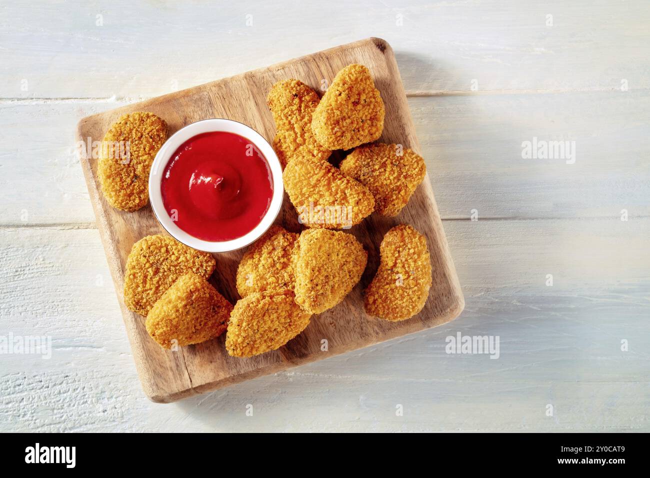 Chicken nuggets with bbq sauce on a rustic wooden background, top shot ...