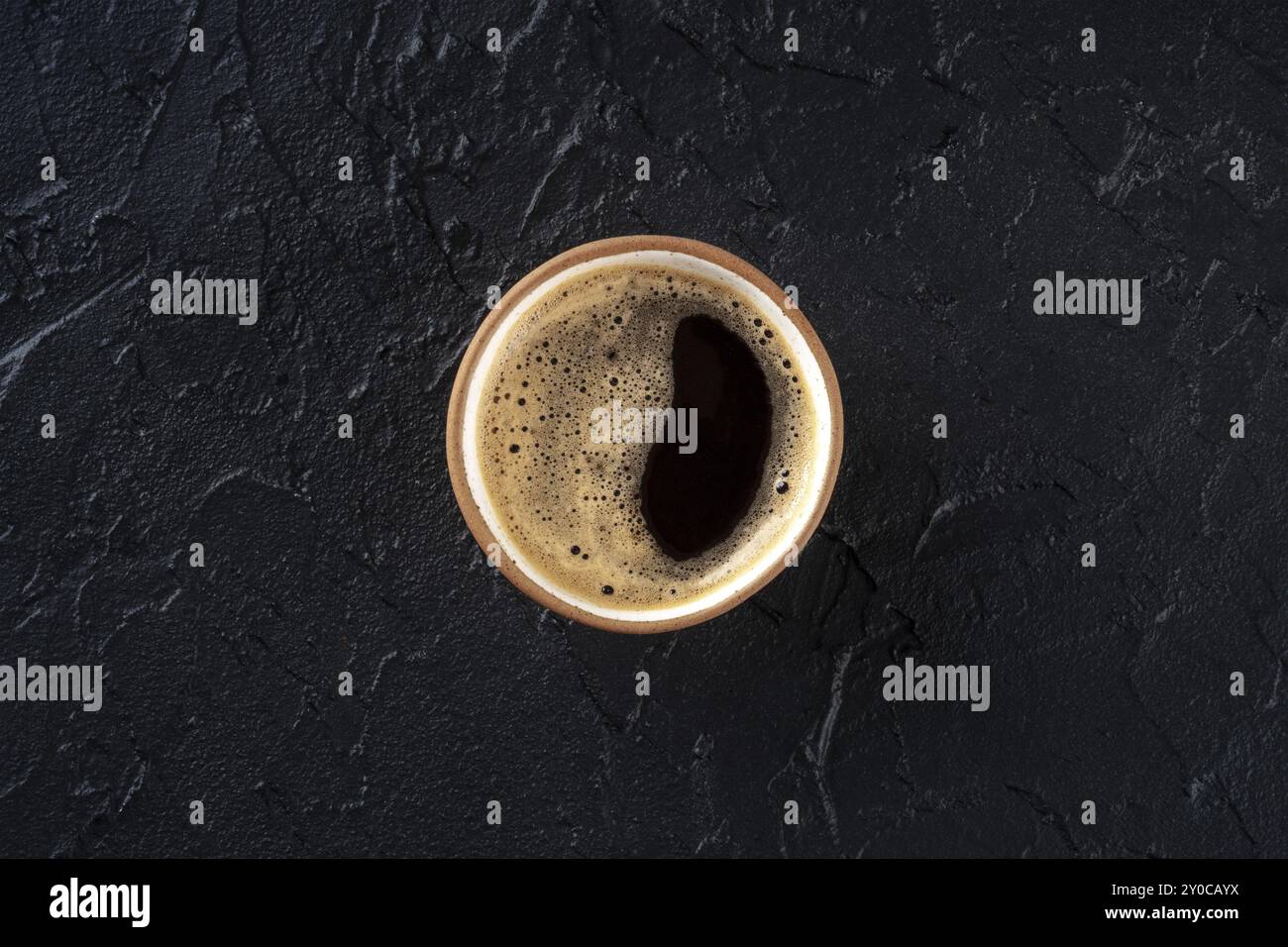 Coffee cup, overhead flat lay shot on a black slate background with a ...
