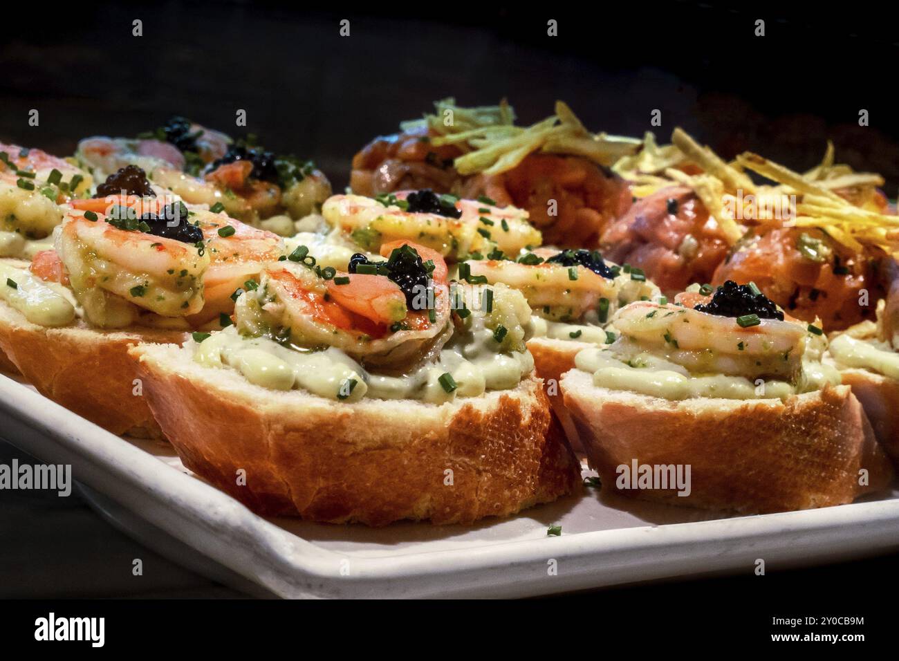 Tapas and pinchos at a food market in Spain. Traditional Spanish ...