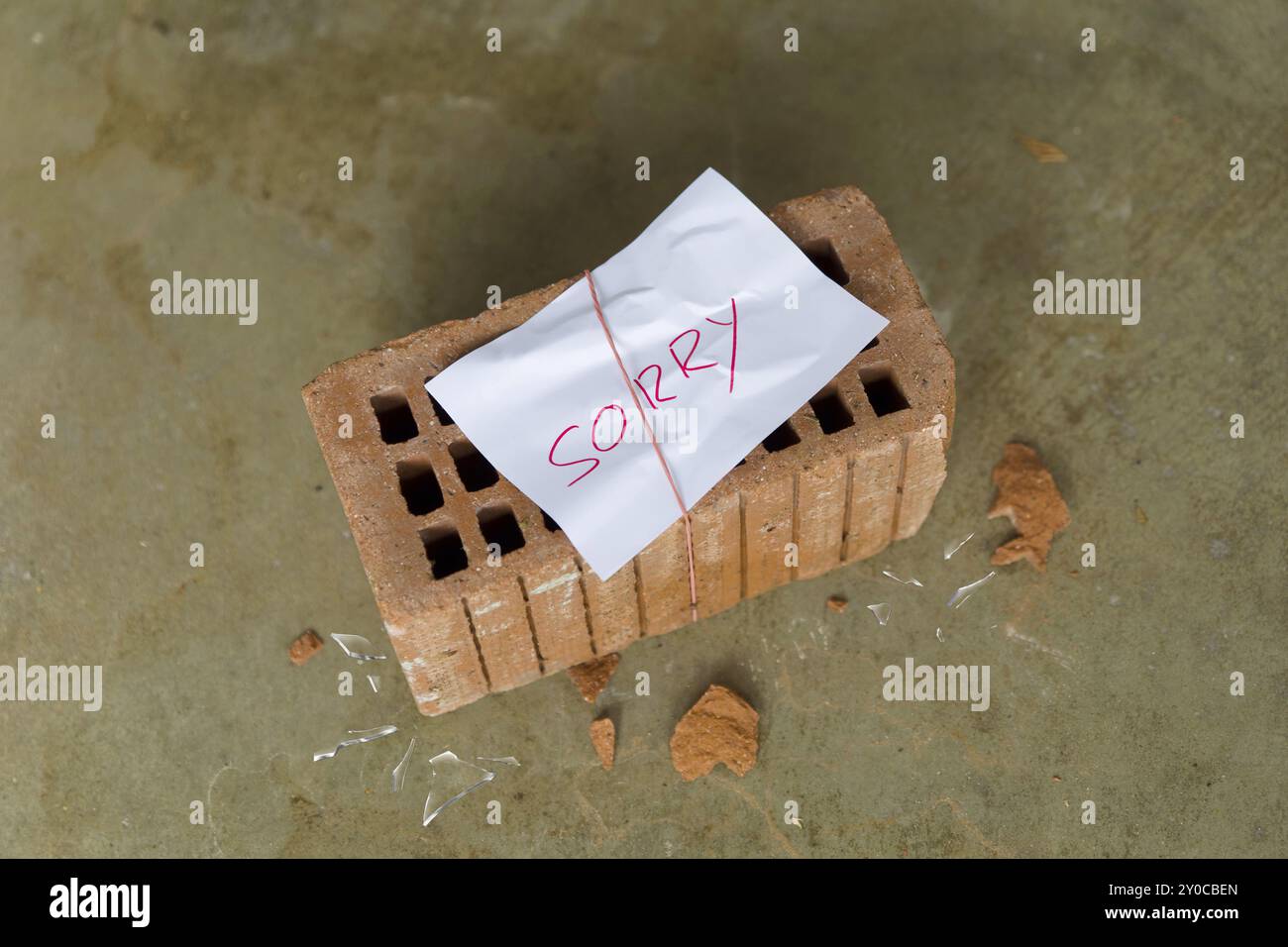 Brick with the note Sorry, symbolic image Stock Photo - Alamy