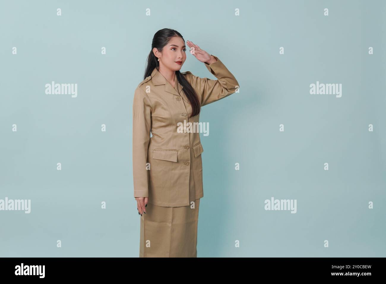 Confident Indonesian government worker wearing a khaki uniform doing ...