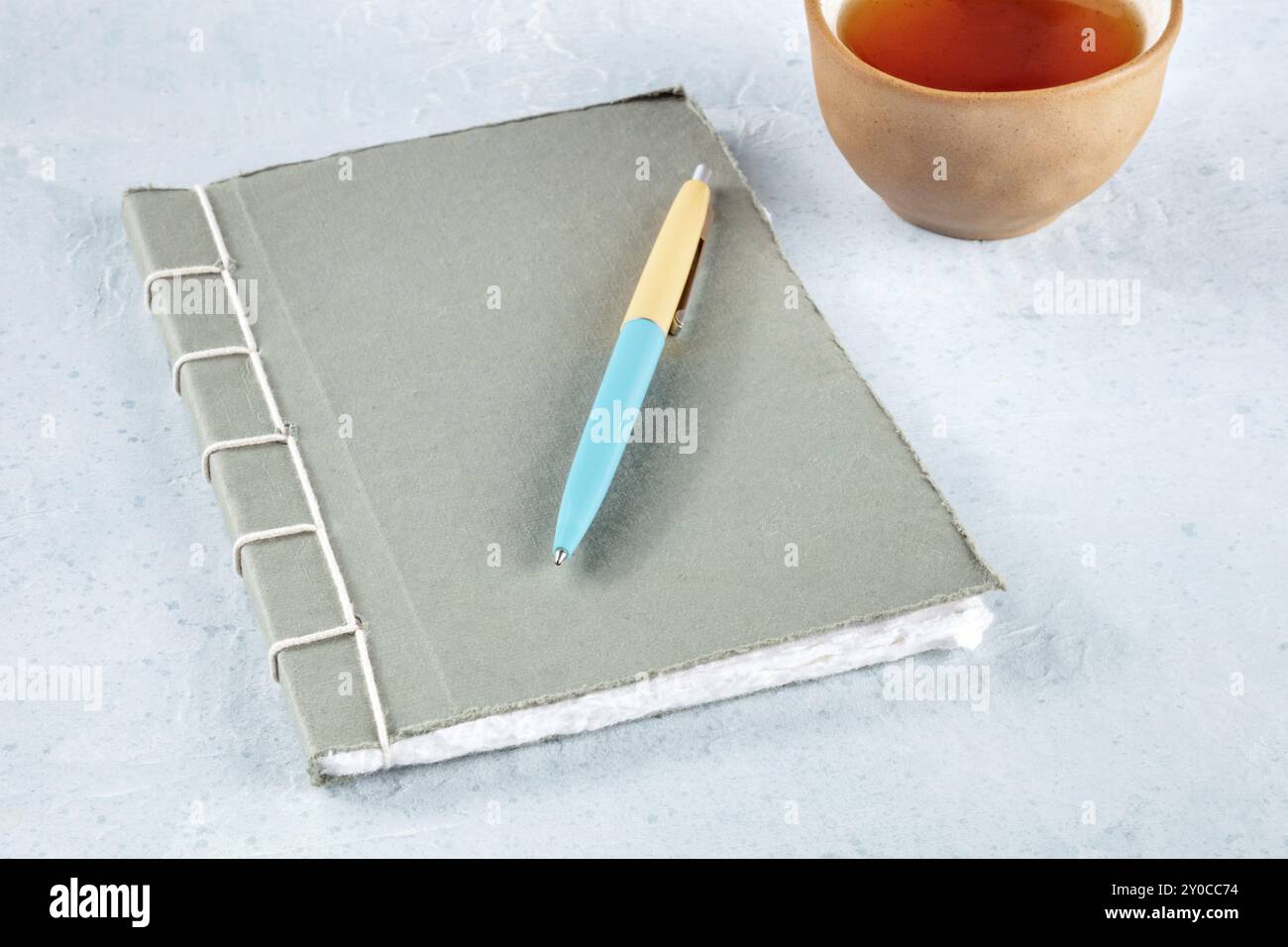 Diary. A handmade stitched journal with a pen and a cup of tea ...