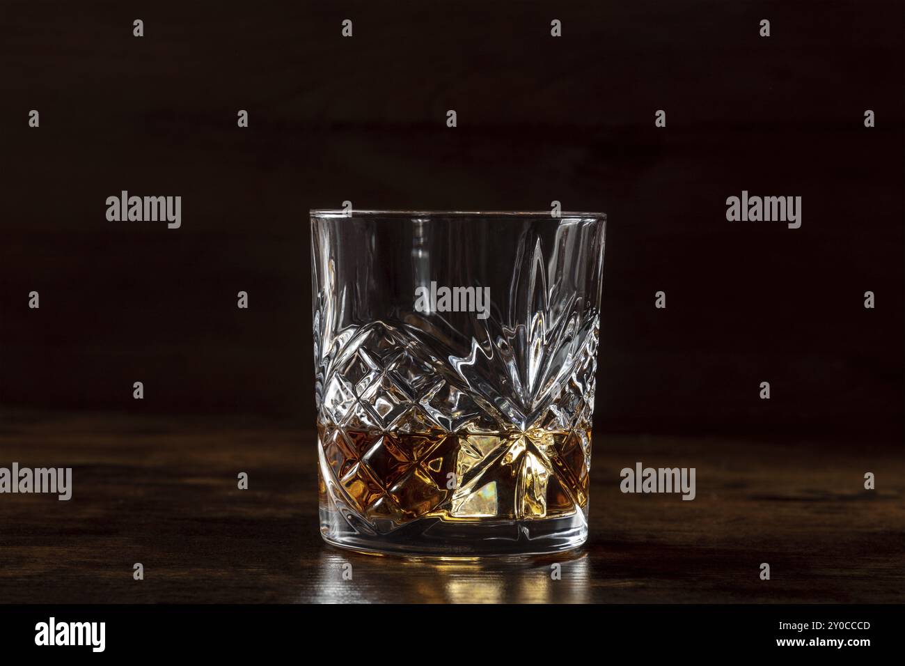 Whiskey in a glass with ice. Bourbon whisky on rocks on a dark ...