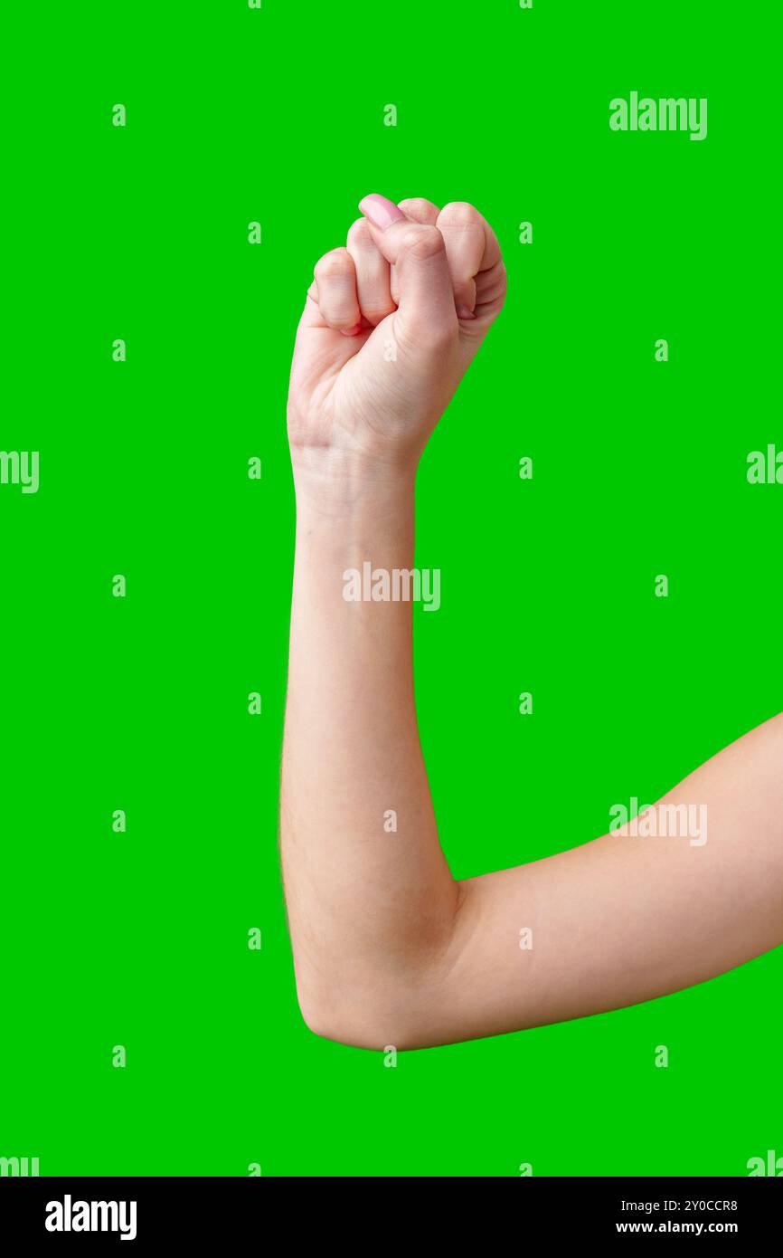 Woman's Arm With Fist Raised Against Green Screen Stock Photo - Alamy