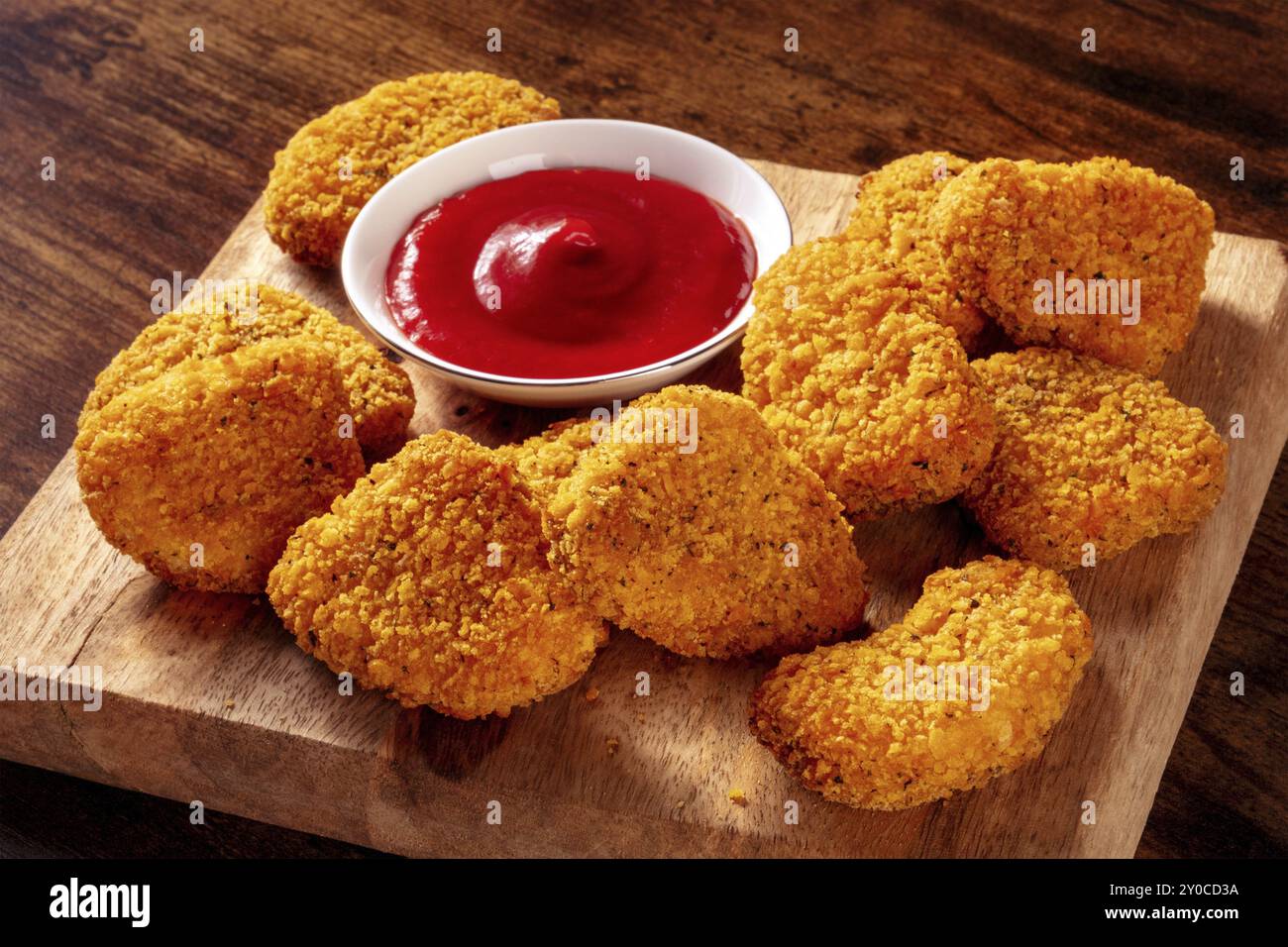 Chicken nuggets with ketchup on a rustic wooden background. A crispy ...