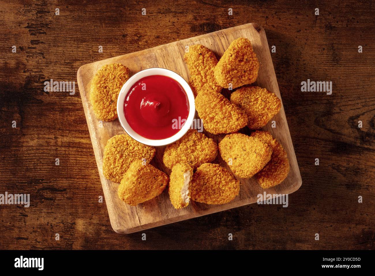 Chicken nuggets on a rustic wooden table, overhead flat lay shot. A ...
