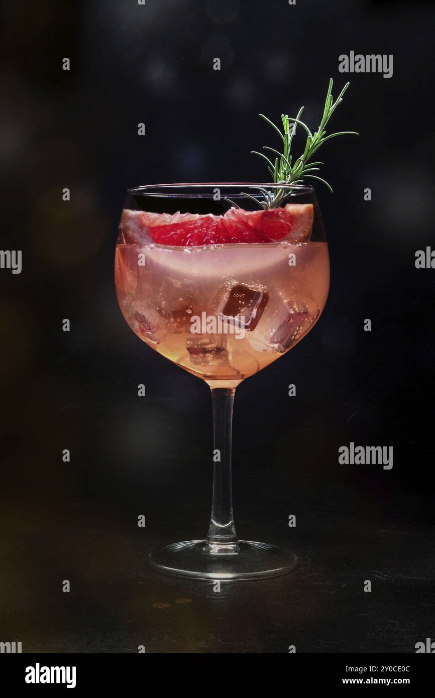 Fancy cocktail with fresh fruit. Gin and tonic drink with ice at a ...