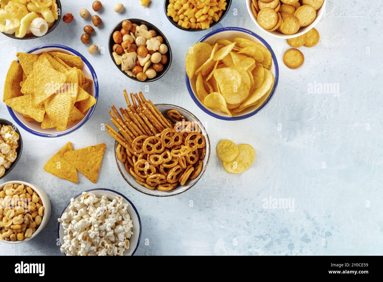 Salty snacks, party mix, shot from the top with copy space. An ...