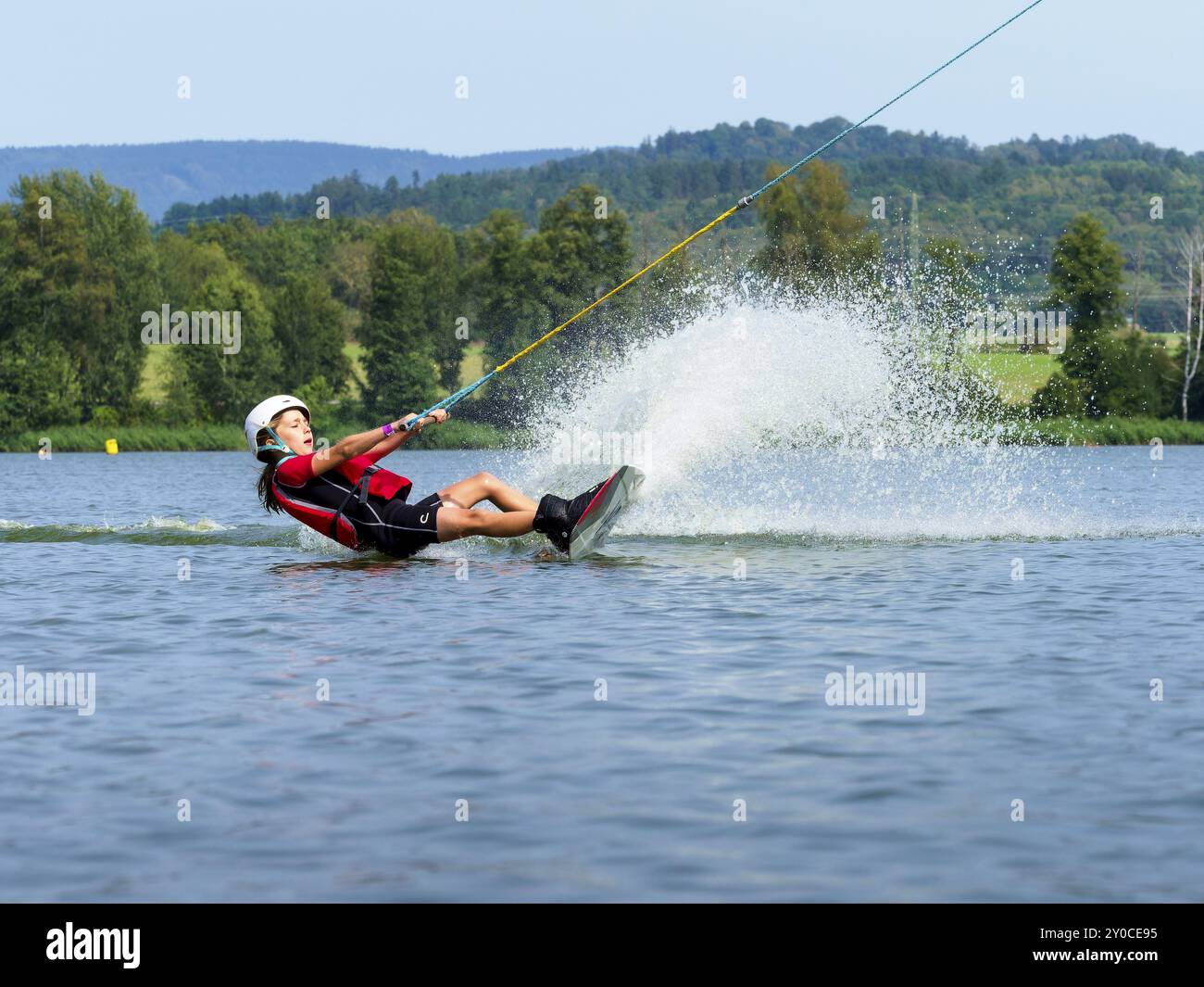 Boy or girl, summer holiday with wakeboard, water splashes, red life ...