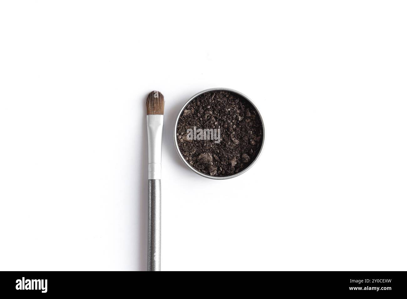 Dark brown face shadow in container and eye shadow or make-up brush ...