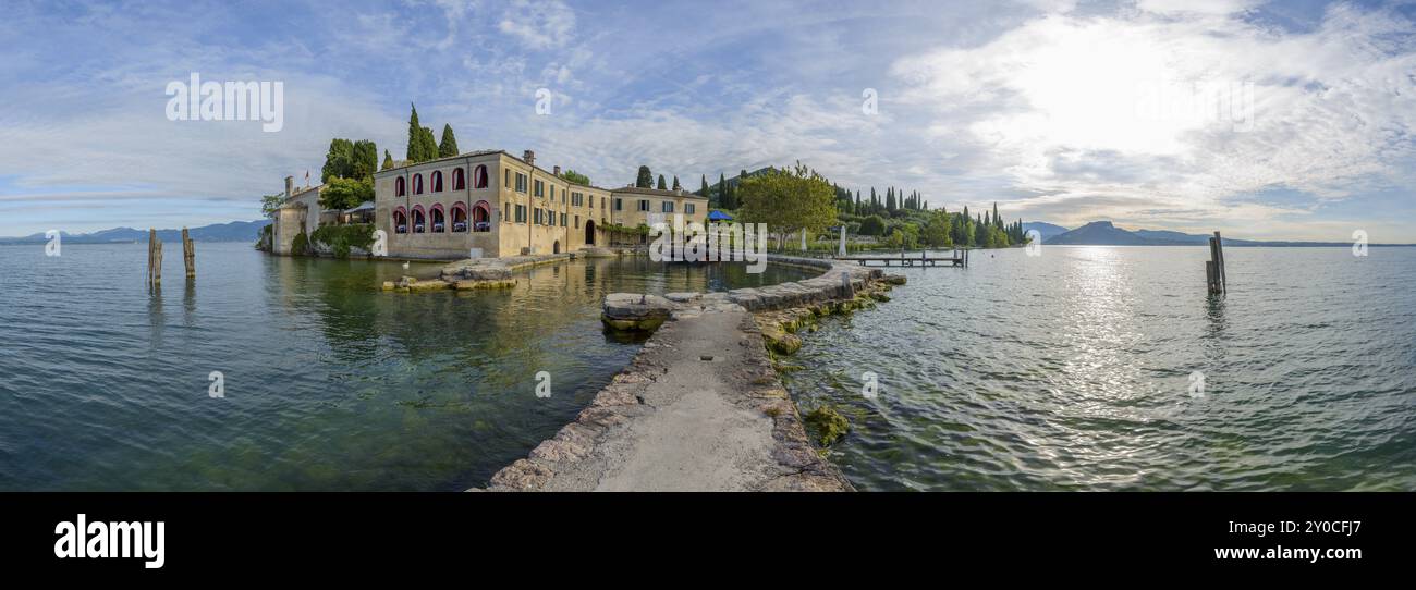 A serene view of a historic lakeside building by a calm lake with a ...