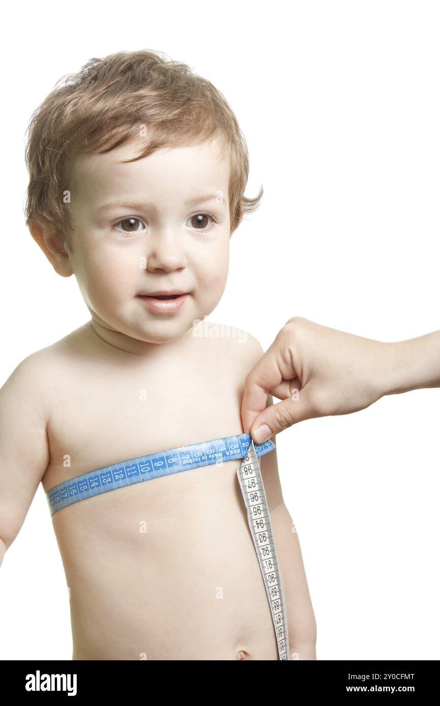 Measure tape in hand measuring human child chest Stock Photo - Alamy