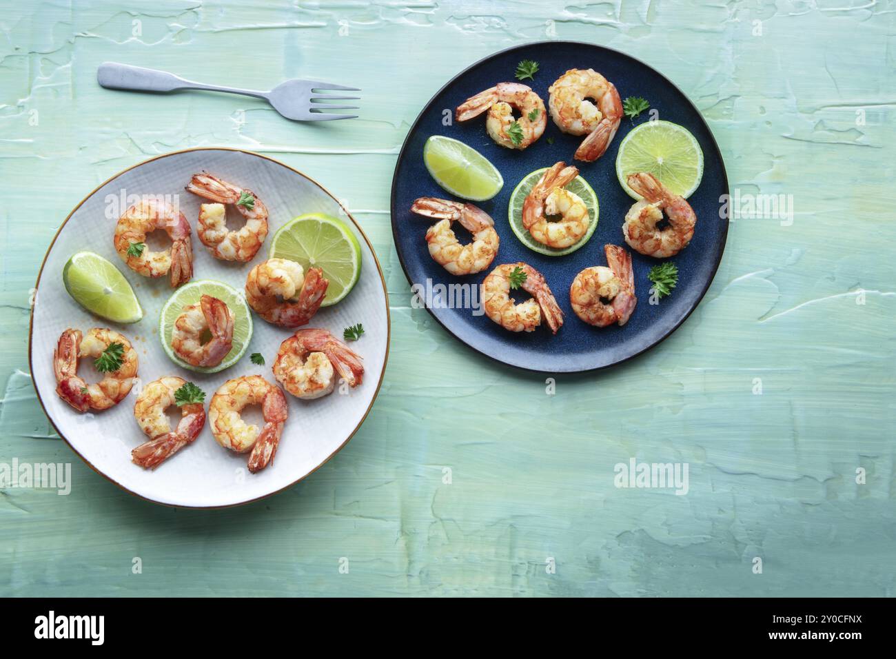 Shrimps, overhead flat lay shot on a teal blue background, with copy ...