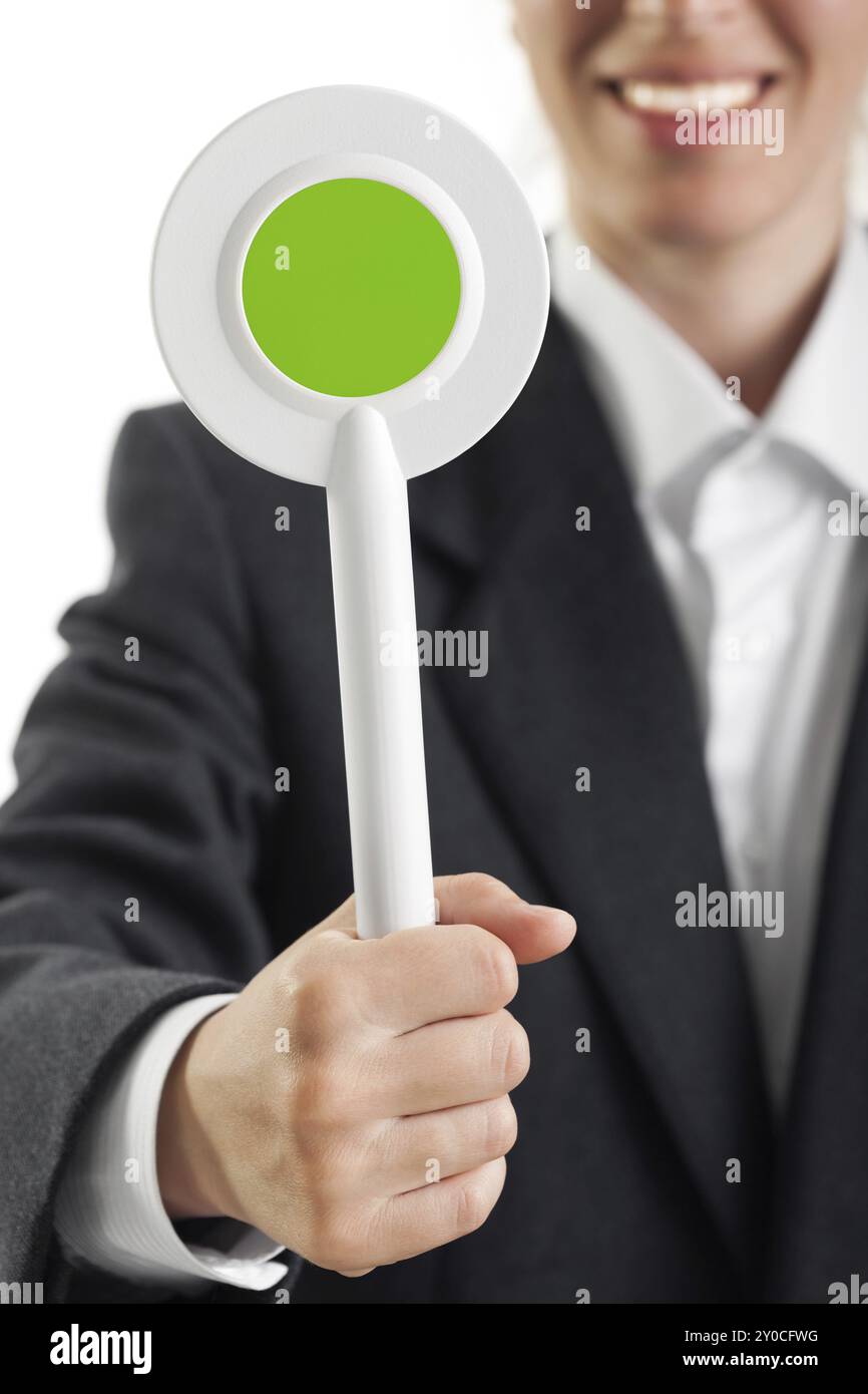 Human hand holding auction paddle voting card sign Stock Photo - Alamy