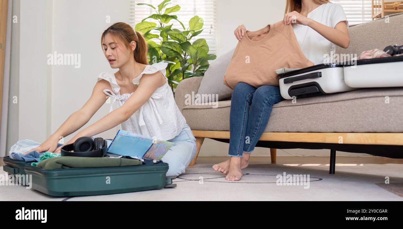 Women packing suitcase and choosing travel outfits Stock Photo - Alamy