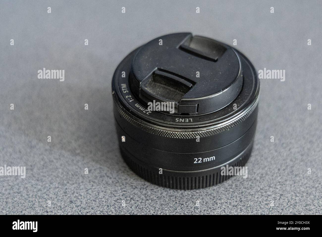 Small pancake lens in size of 22mm, lying on the ground. Lens of small ...