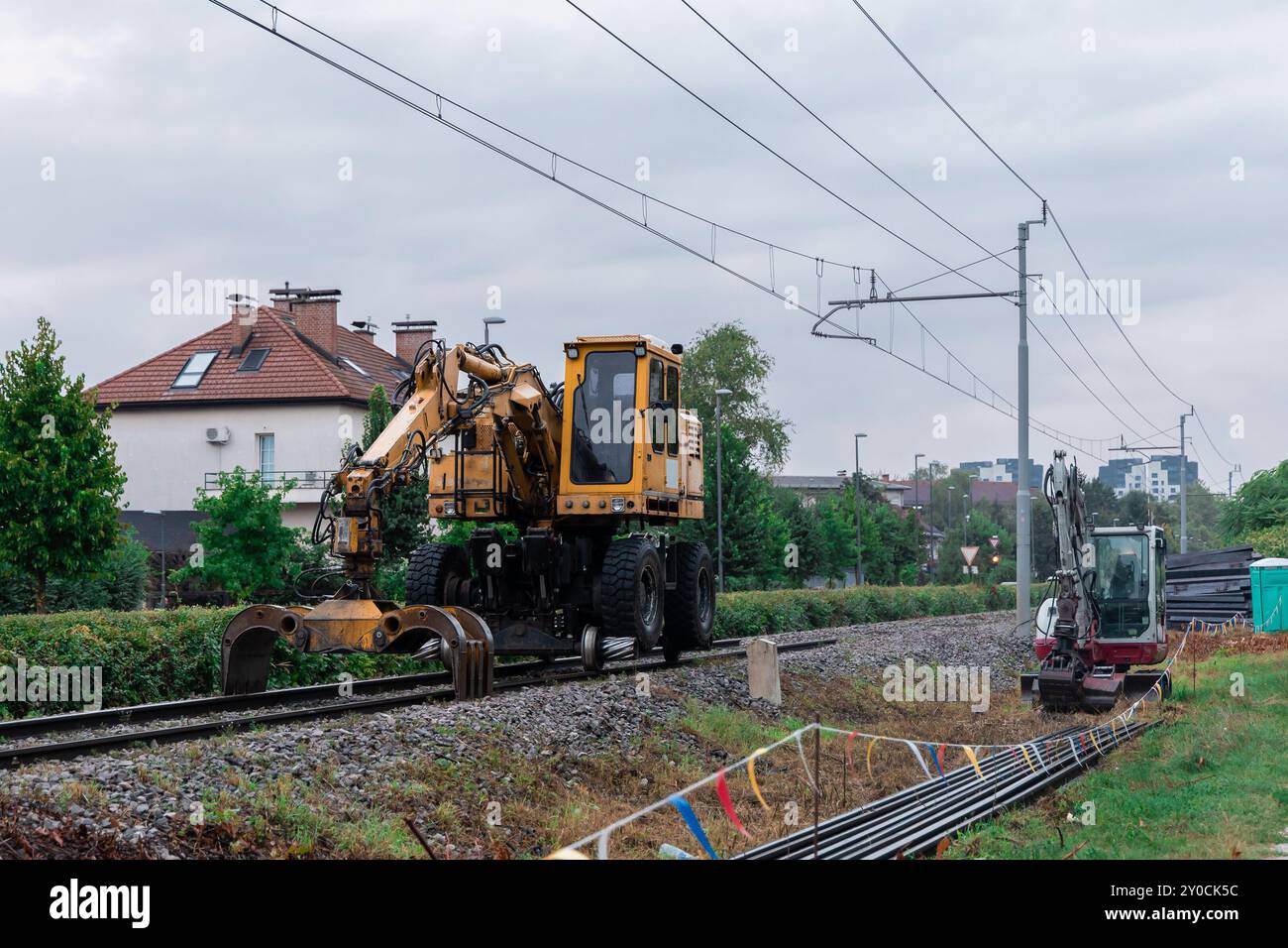 Two way vehicle or digger with rubber wheels and train wheels resting ...