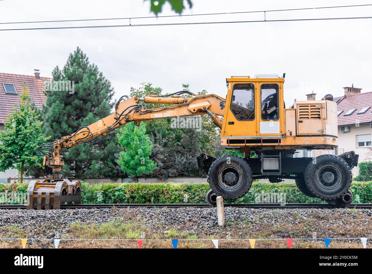 Two way vehicle or digger with rubber wheels and train wheels resting ...