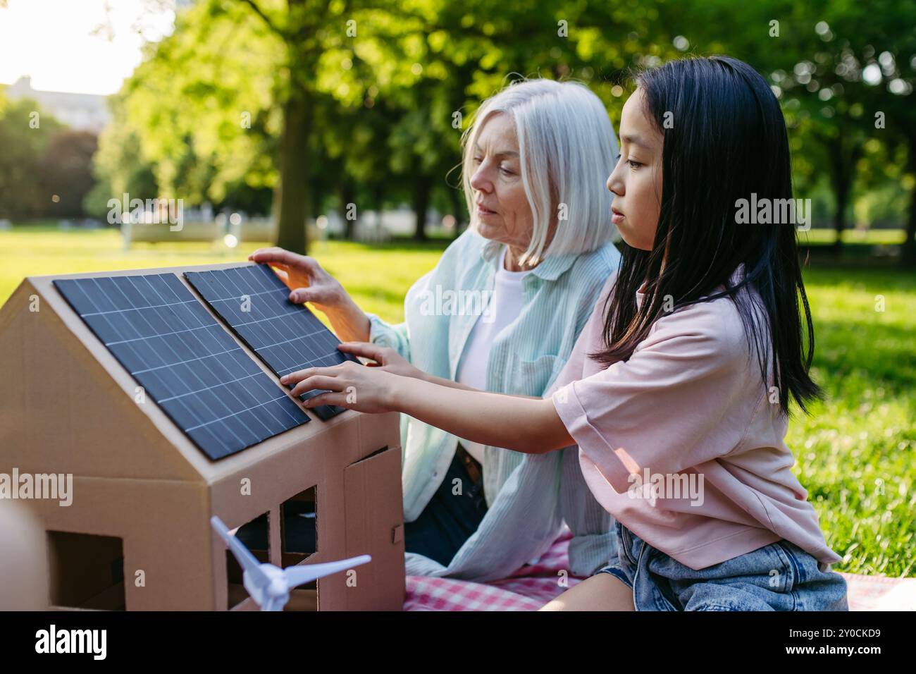 Girl learning about renewable energy and solar panels during ...