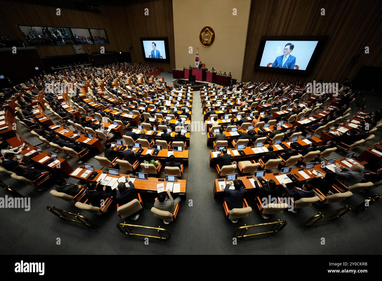 South Korea's National Assembly Speaker Woo Won-shik, on the screens ...