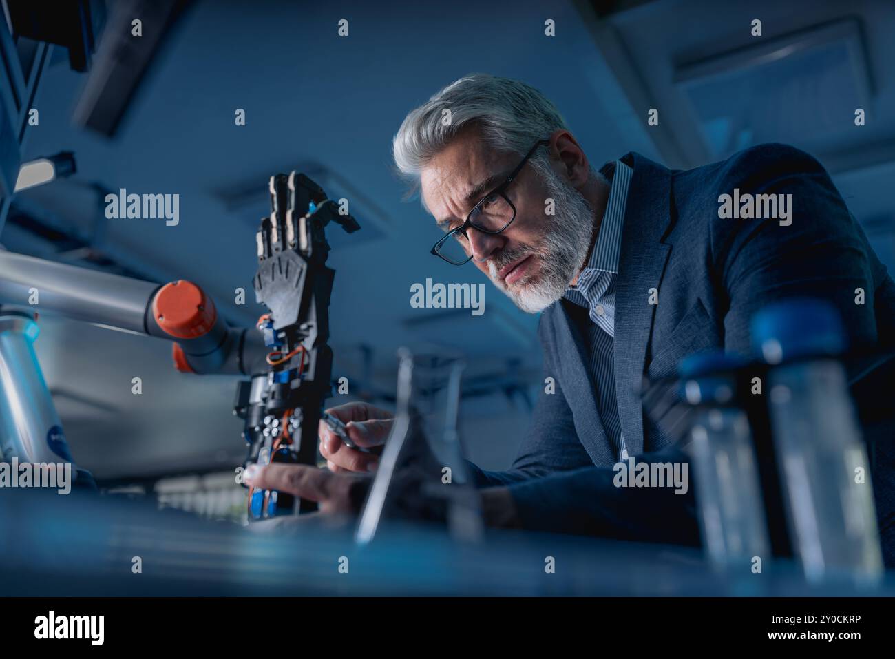 Robotics engineer adjusting, calibring robotic prosthetic hand. Concept ...